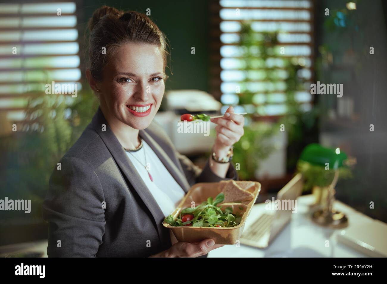 Sustainable workplace. happy modern 40 years old bookkeeper woman in a ...