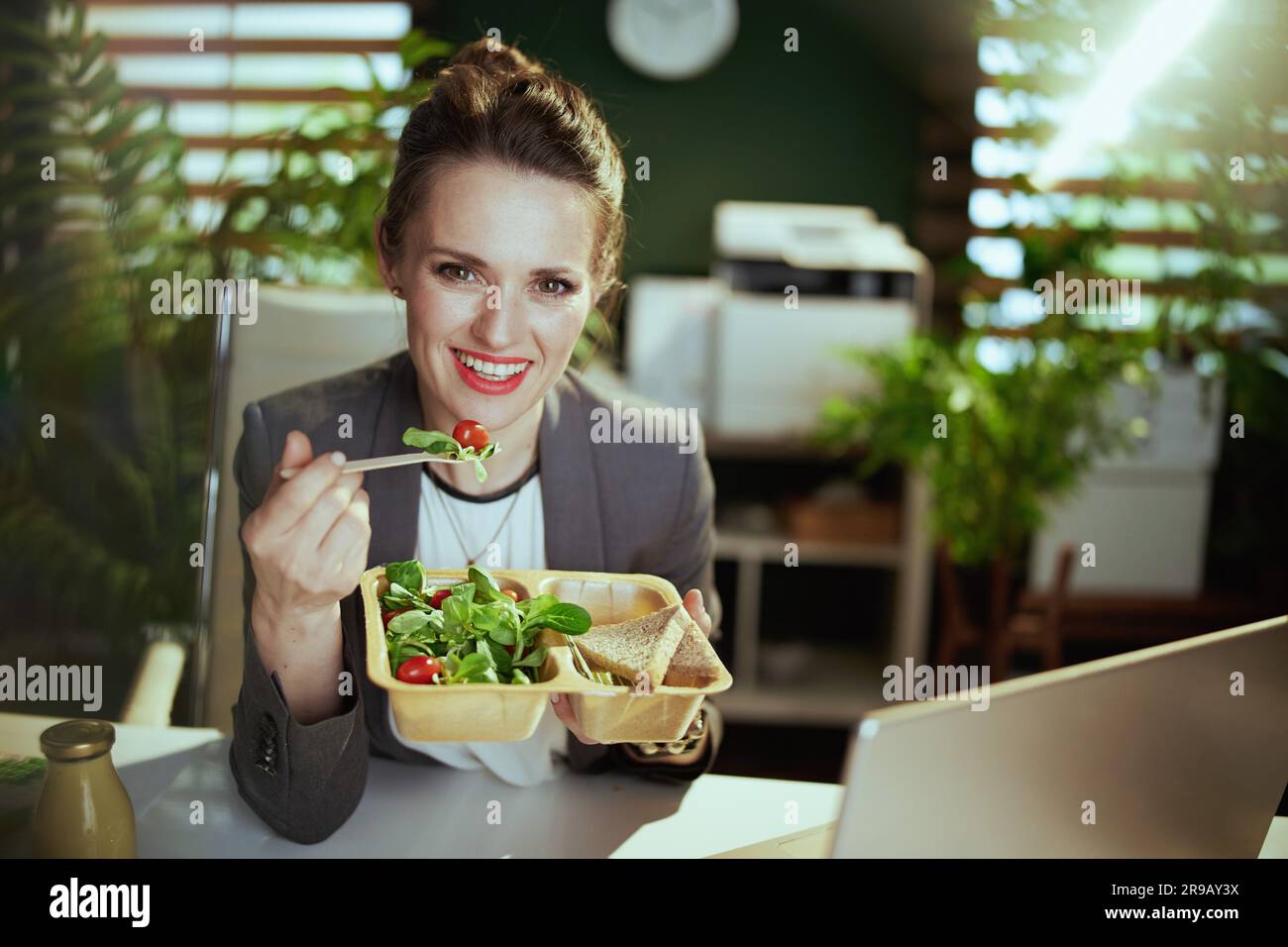 Sustainable workplace. happy modern 40 years old woman employee in a ...