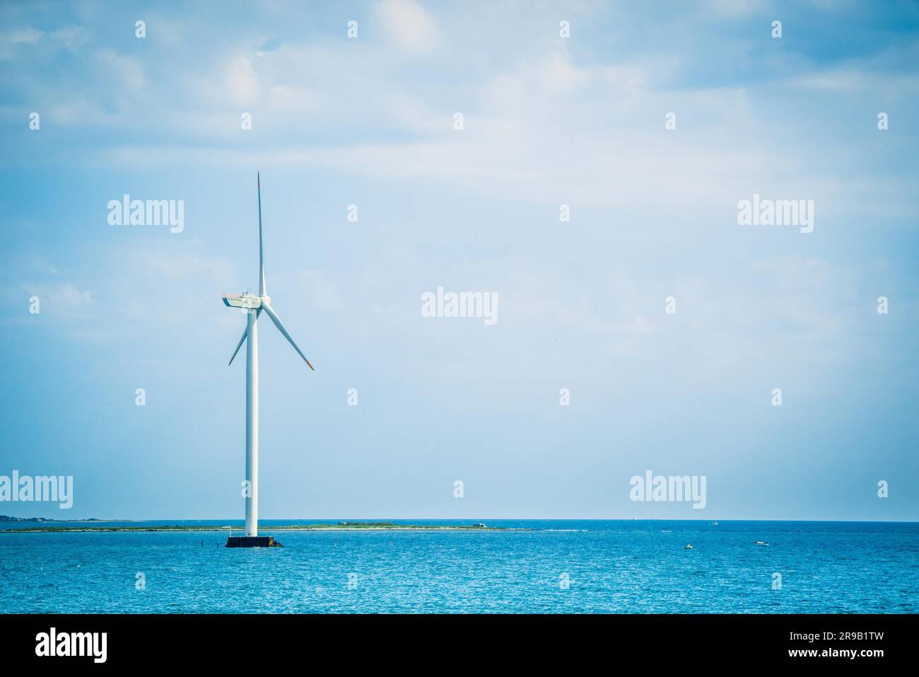 Single windmill in the oceran by the coast Stock Photo - Alamy