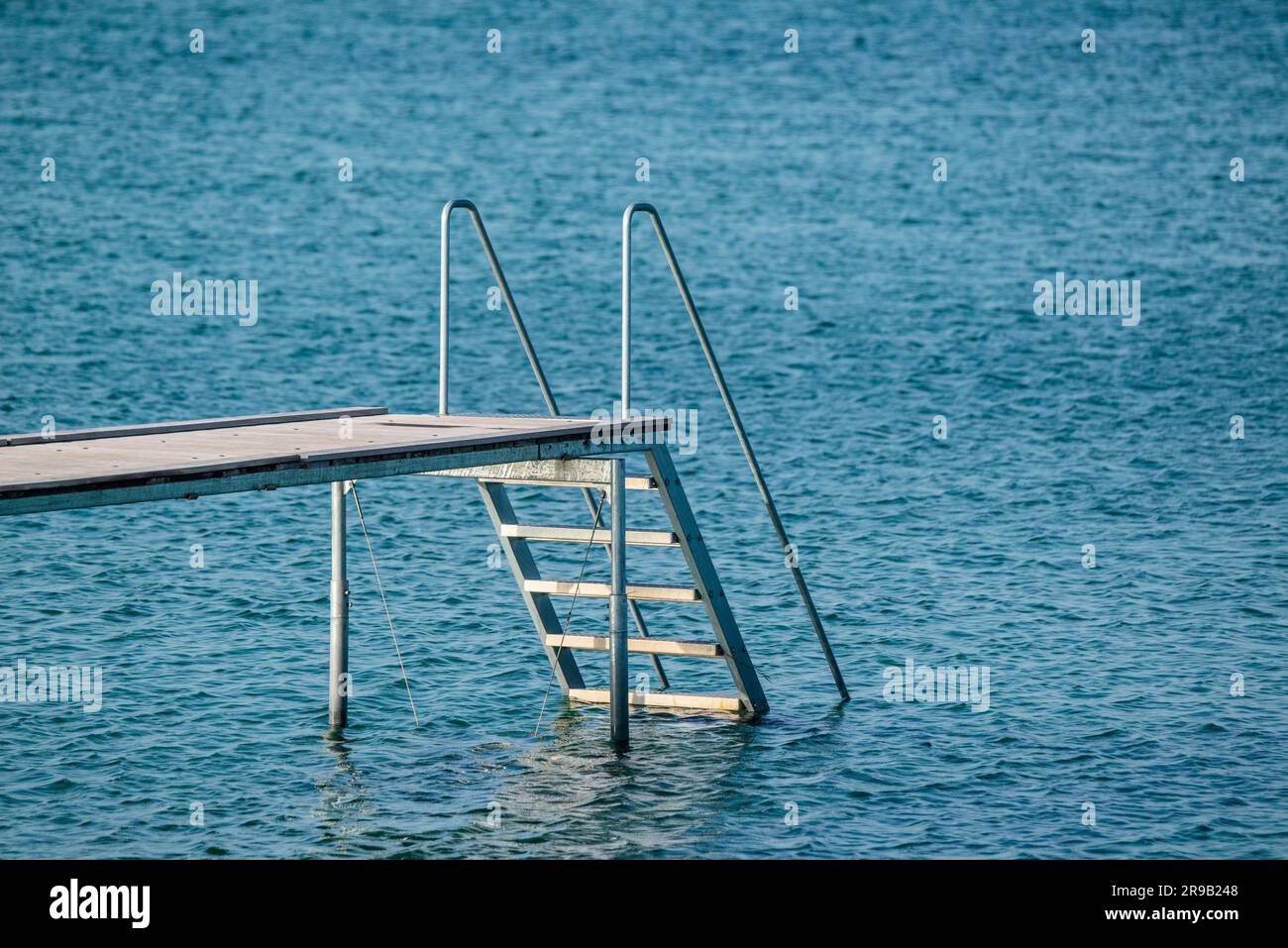 Jetty with a ladder at a blue ocean Stock Photo - Alamy