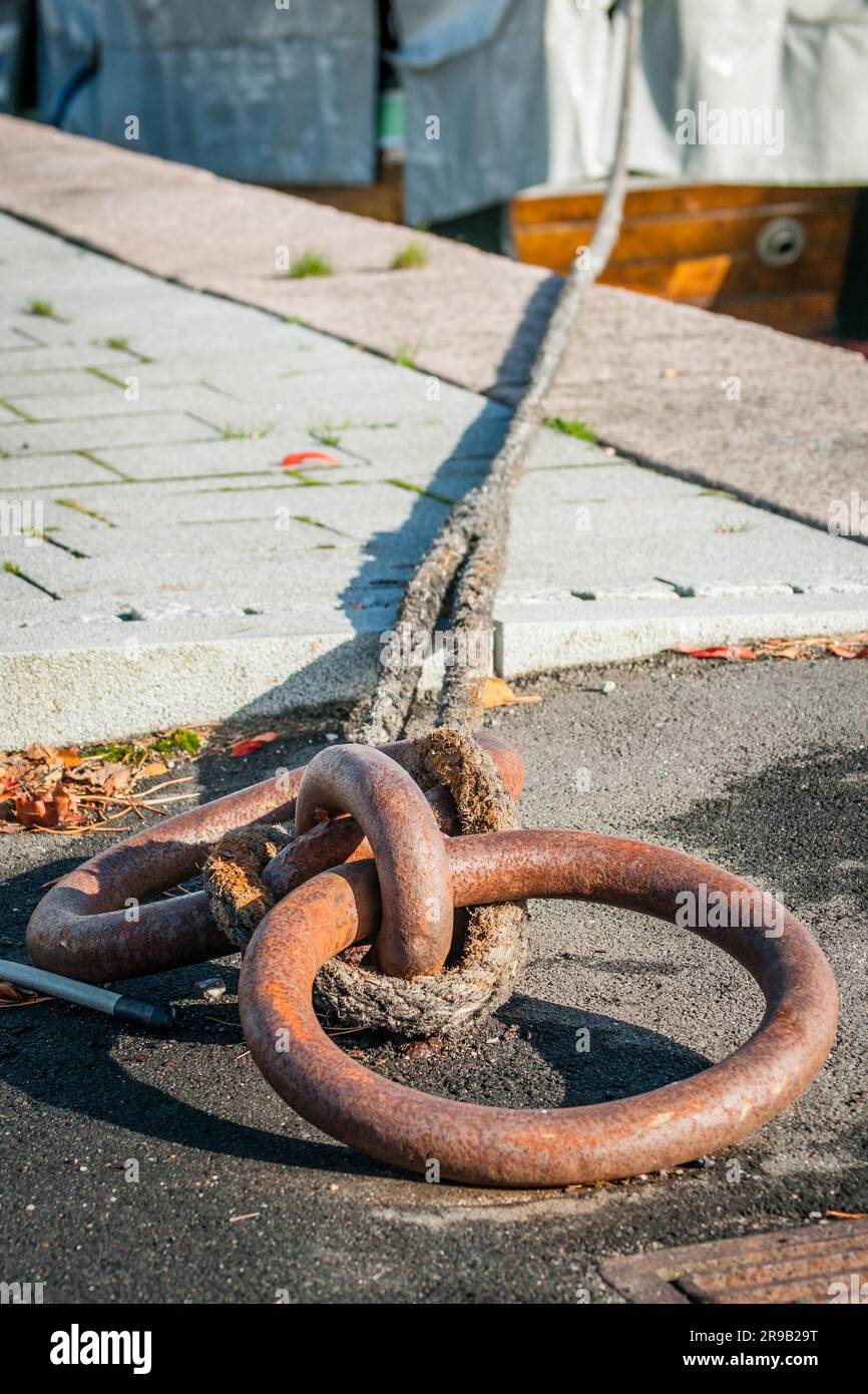 Ship anchored to a post at the harbor Stock Photo - Alamy