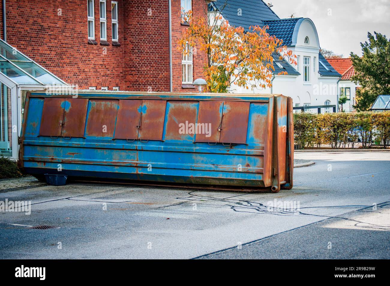 Large blue container with rust on the street Stock Photo - Alamy