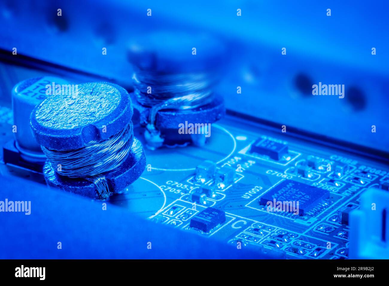 Tech board with capacitors and chips in blue color Stock Photo - Alamy