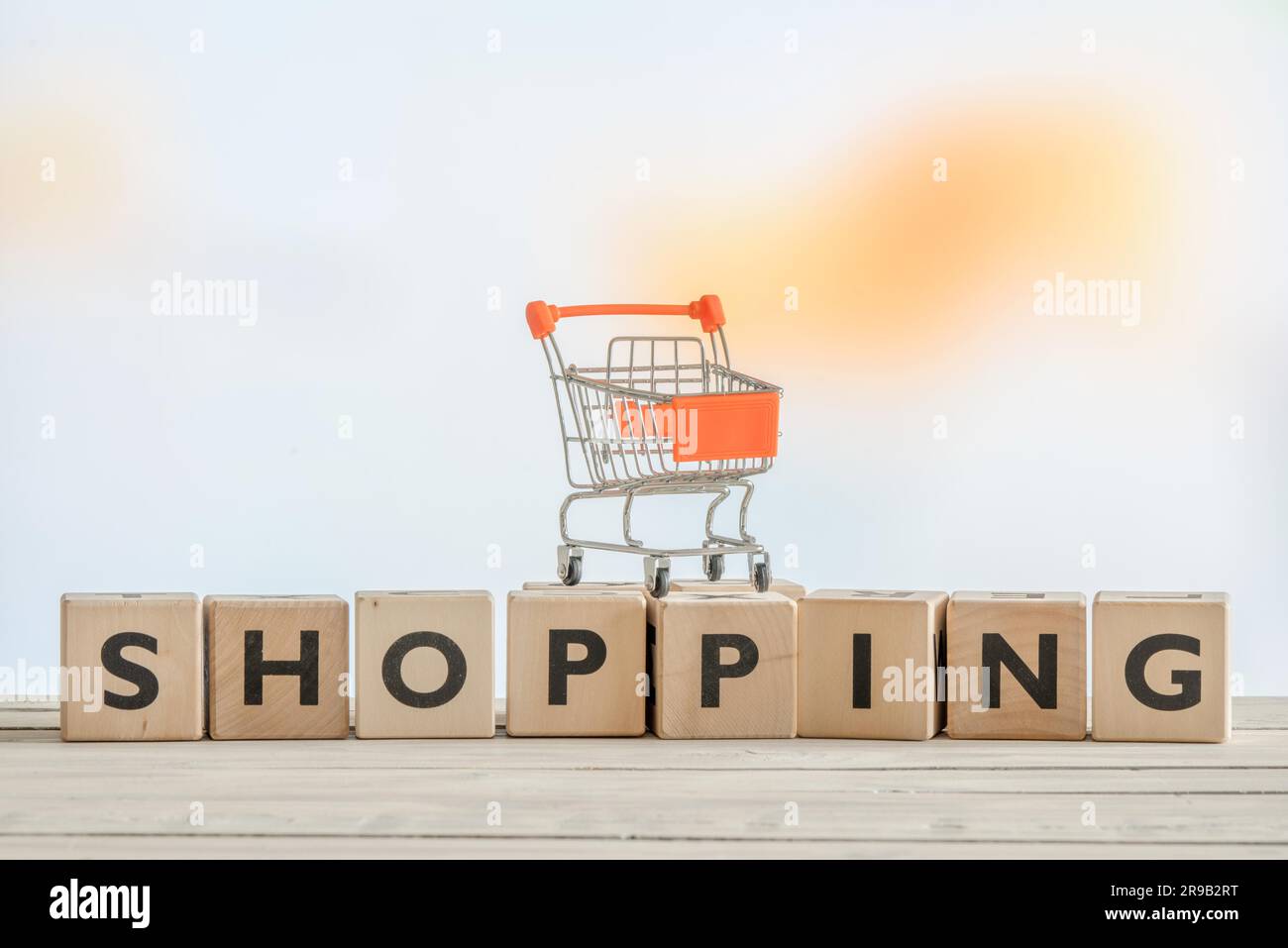Wooden shopping sign with an orange cart Stock Photo - Alamy