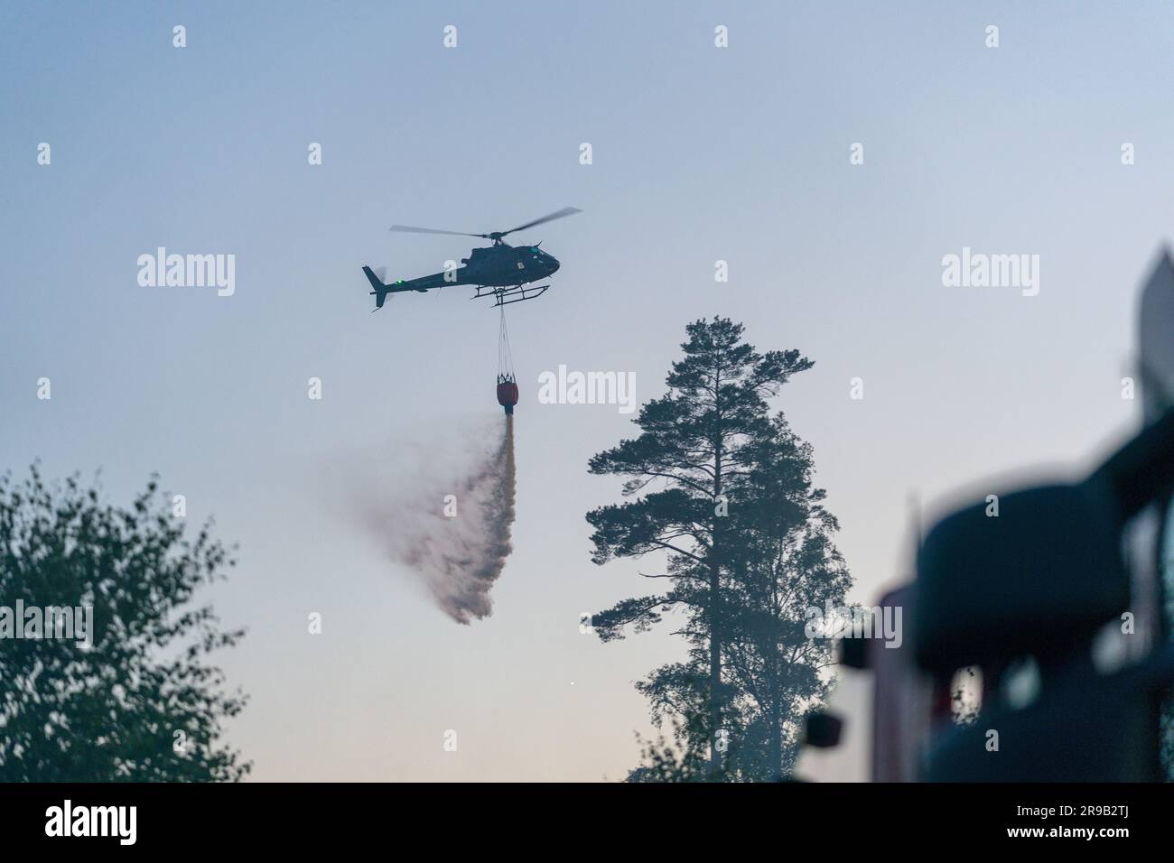 Broby, Sweden, 25 June, 2023 Helicopters water bombing a wildfire in ...