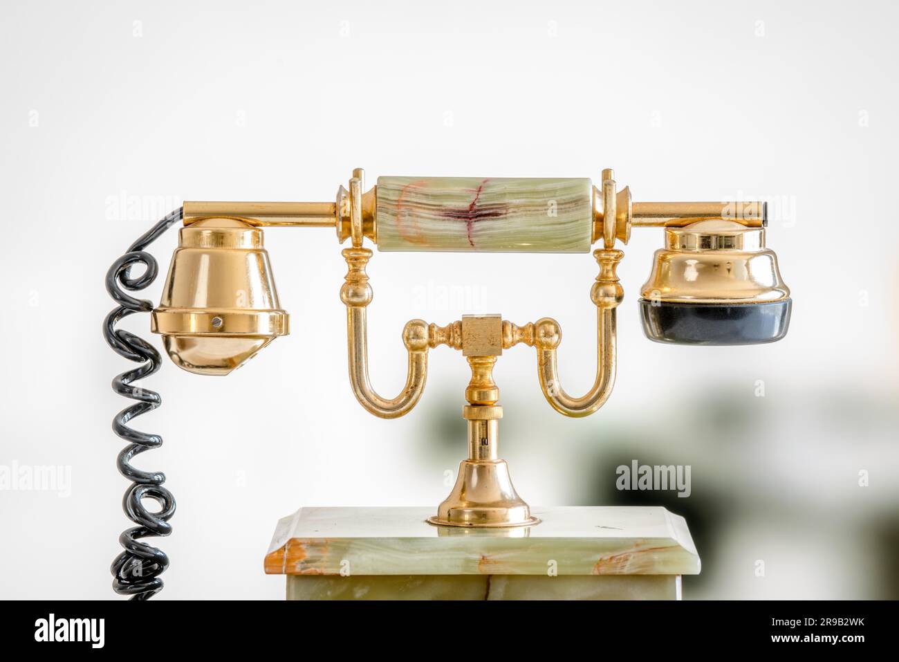 Golden telephone in retro style on white background Stock Photo - Alamy