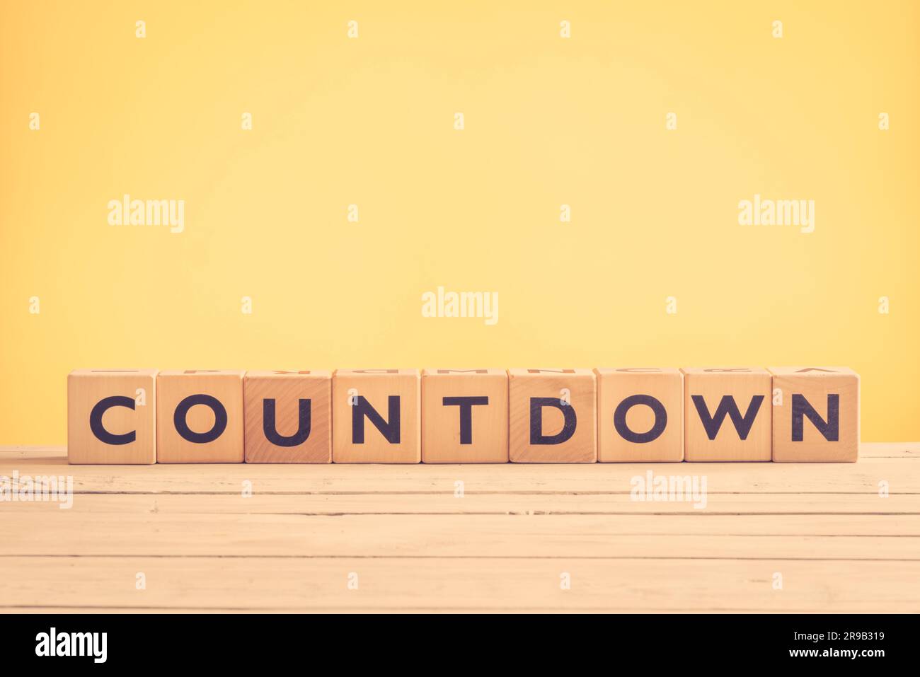 Countdown sign with wooden blocks on yellow background Stock Photo - Alamy