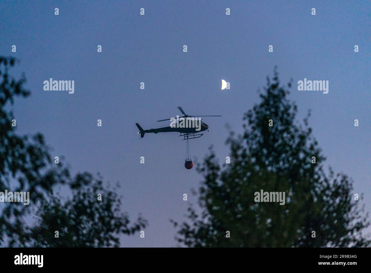 Broby, Sweden, 25 June, 2023 Helicopters water bombing a wildfire in ...