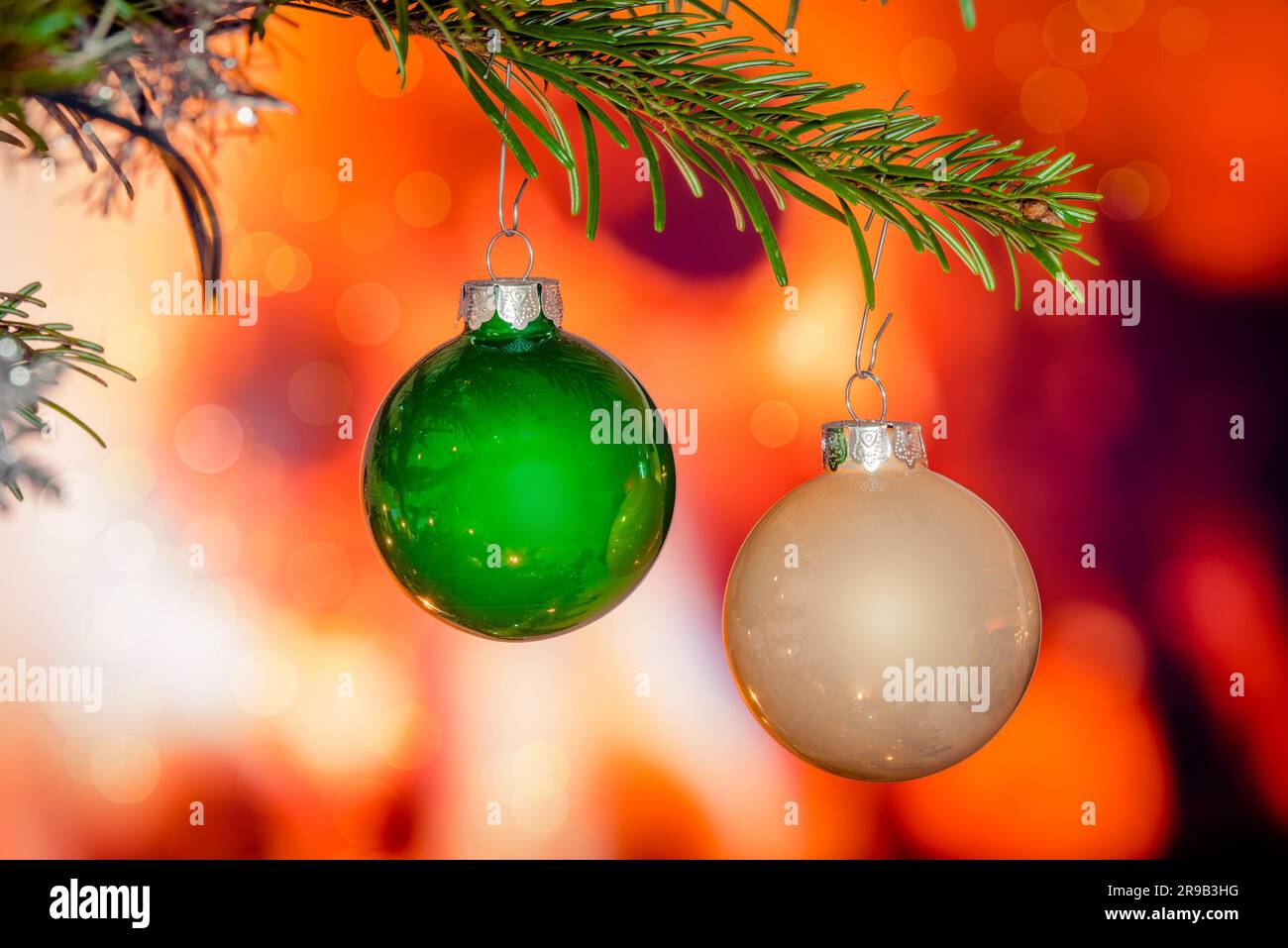 Christmas baubles on a pine branch by a fireplace Stock Photo - Alamy
