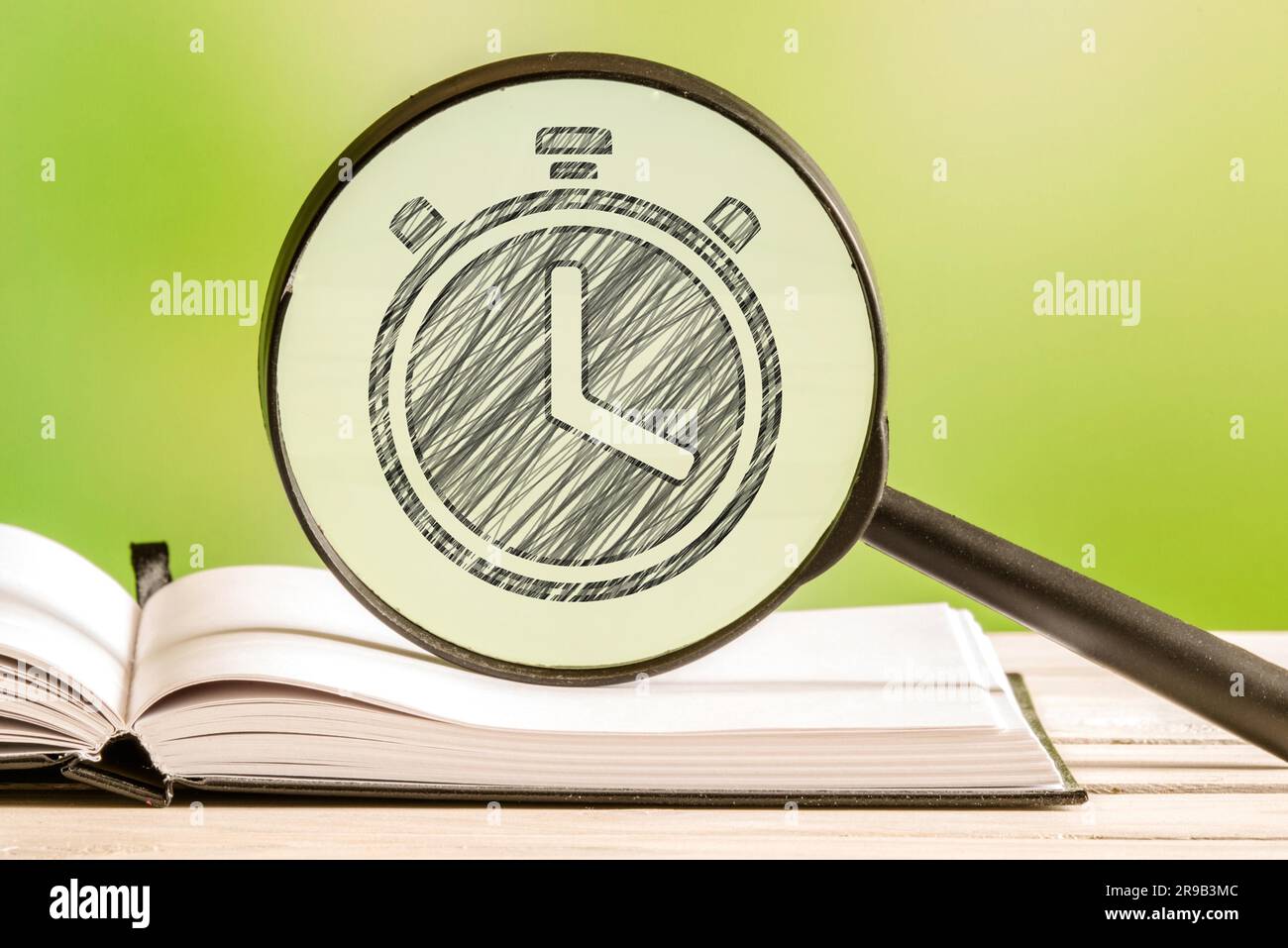 Study deadline with a pencil drawing of a stop watch in a magnifying ...