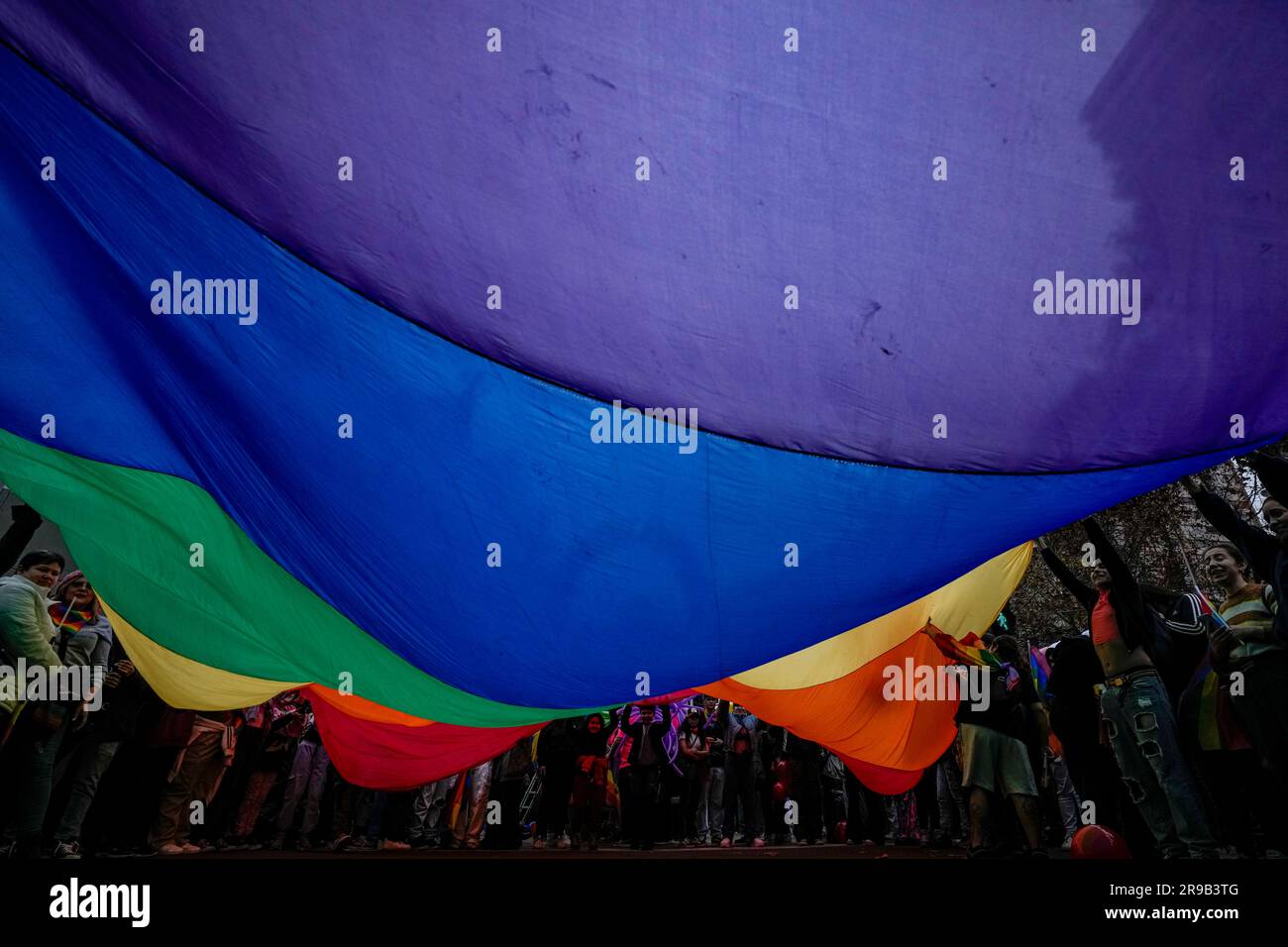 People hold a giant Pride flag during the annual Pride march in ...