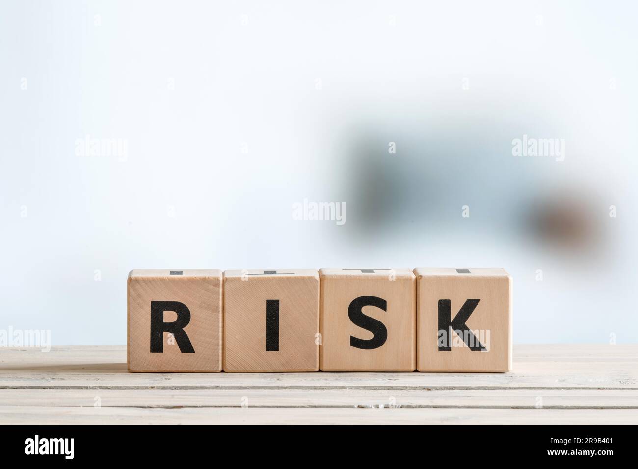 Risk message sign on a wooden office table Stock Photo - Alamy