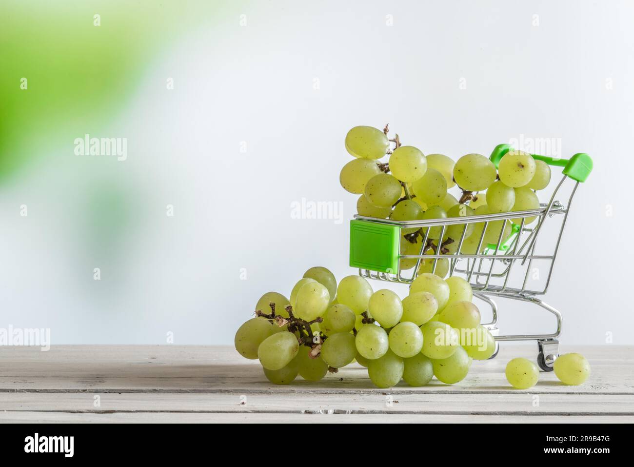 Ripe with green grapes in a shopping cart cart Stock Photo - Alamy