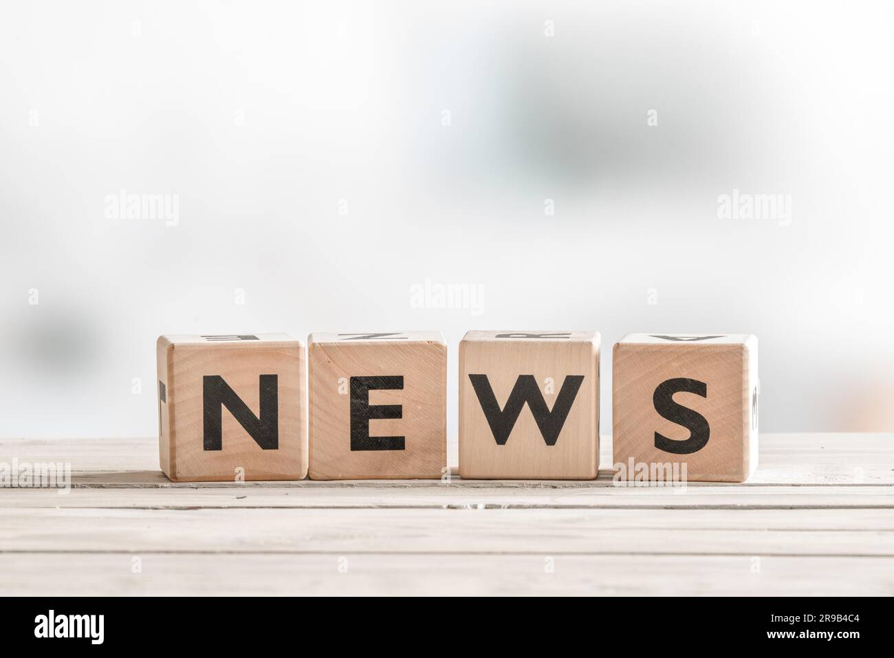 Wooden news sign on a table in an office Stock Photo - Alamy