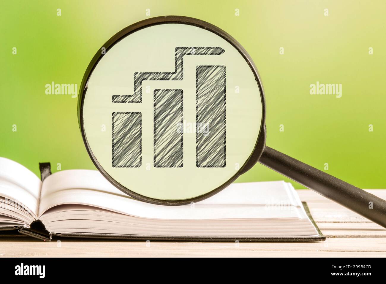 Progress analysis with a pencil drawing of a graph in a magnifying ...