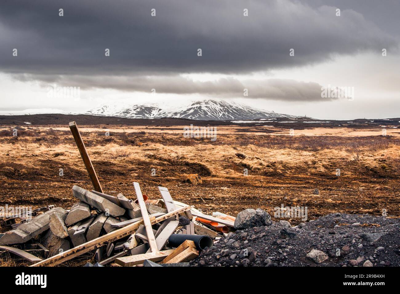 Industrial materials on a rough field with mountains Stock Photo - Alamy