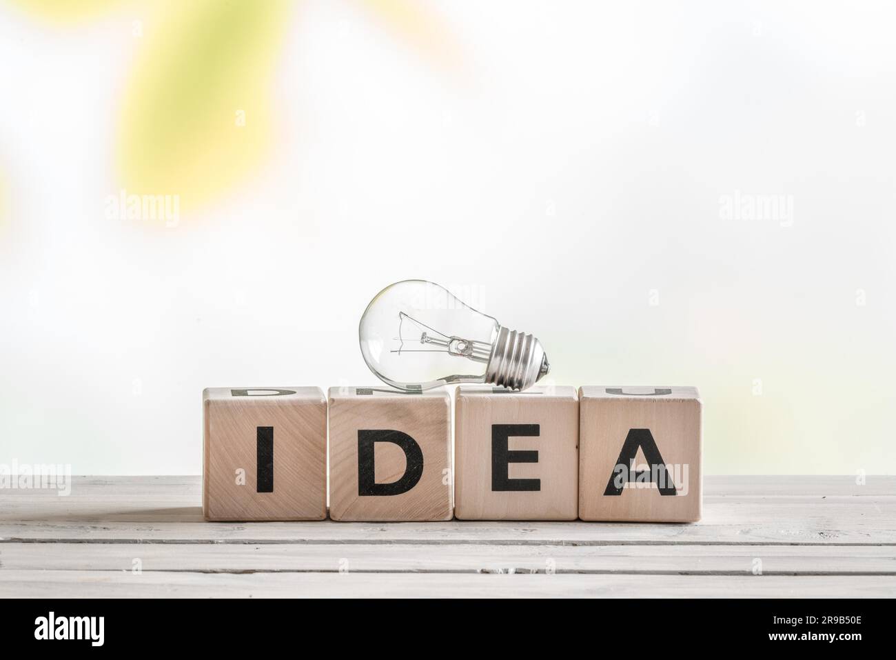 Idea sign with a light bulb on a table Stock Photo - Alamy