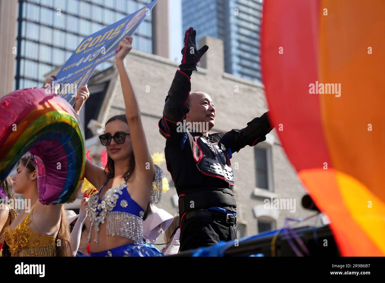 Toronto mayoral candidate Gong Xiao Hua waves from a float as he takes part in the Toronto Pride ...
