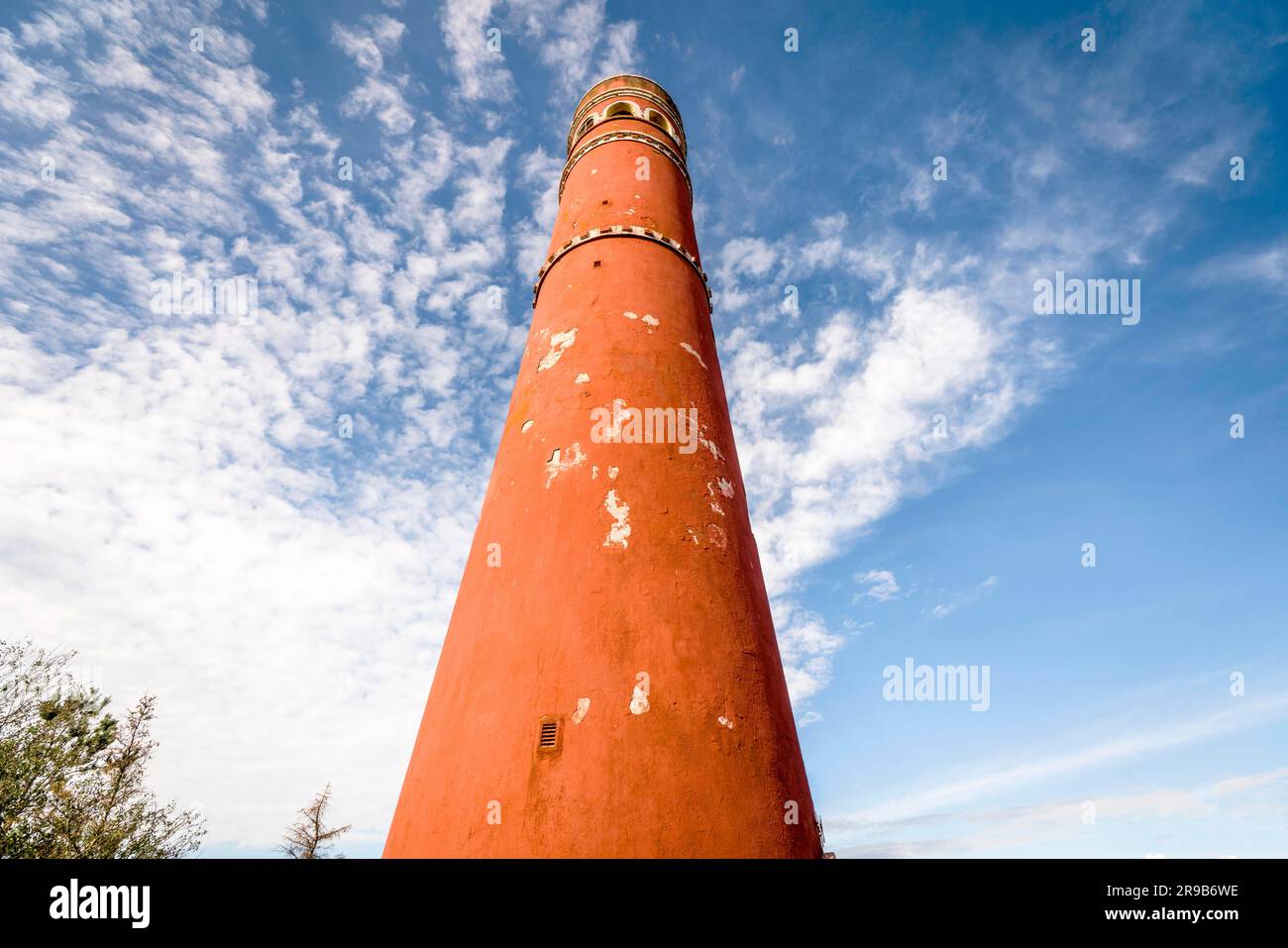 Tall red round tower heading to the sky in the summer seen from below ...