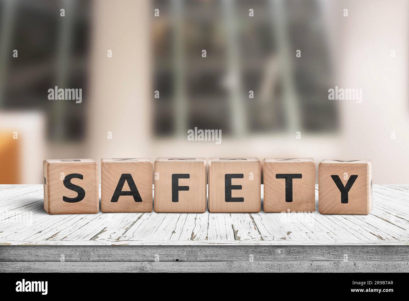 Safety sign on a wooden desk in a room with covered windows in the ...
