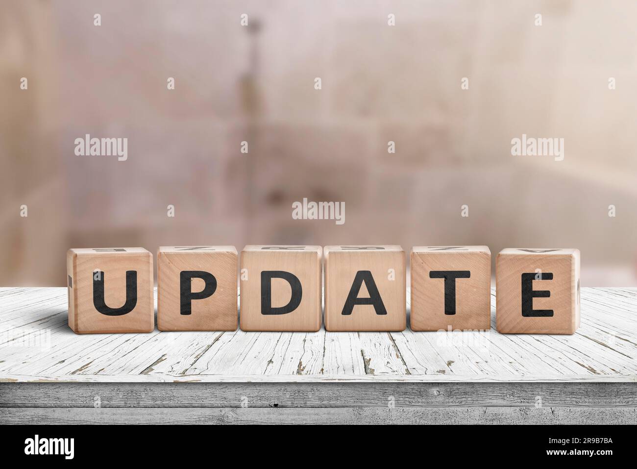 Update message sign on a wooden desk in a room with a blurry background ...