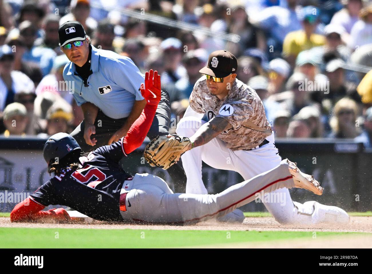 Washington Nationals' CJ Abrams (5) slides into third base ahead of the ...