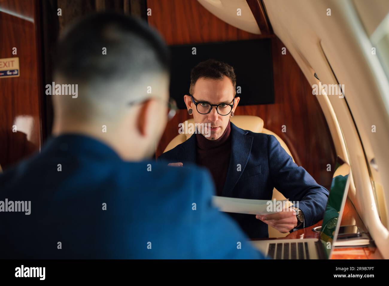 Elegant Businessman couple sitting inside a private airplane jet and ...