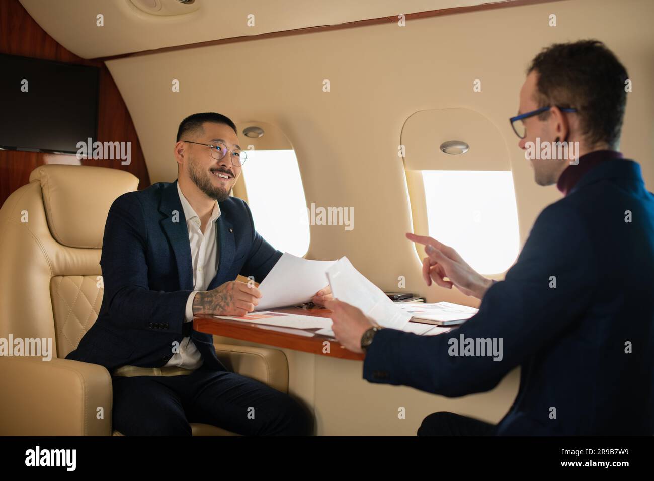 Elegant Businessman couple sitting inside a private airplane jet and ...