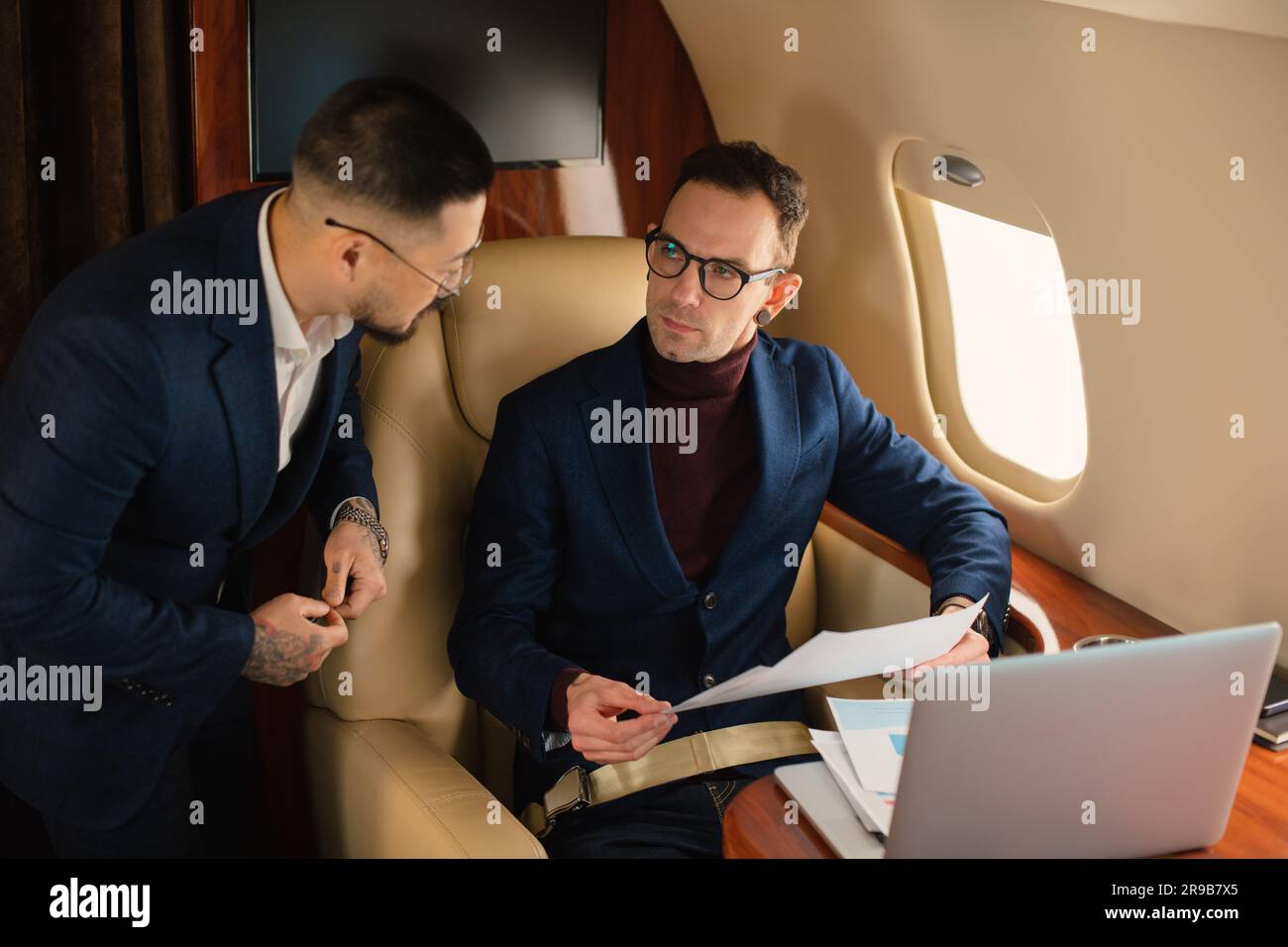 Elegant Businessman couple sitting inside a private airplane jet and ...