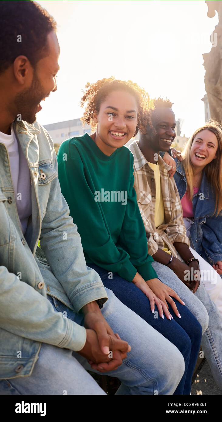 Side view of multiethnic group of Erasmus friends ganging out outdoors ...