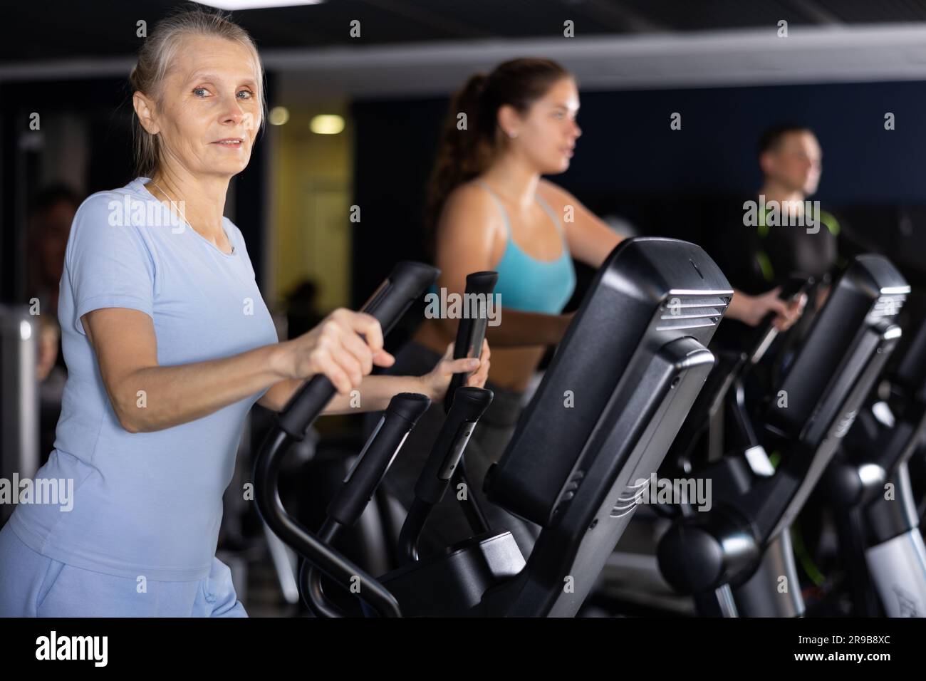 Woman working out on elliptical hi-res stock photography and images - Alamy