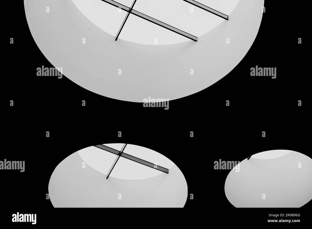 Three white circular discs arranged in a row in a staggered formation ...