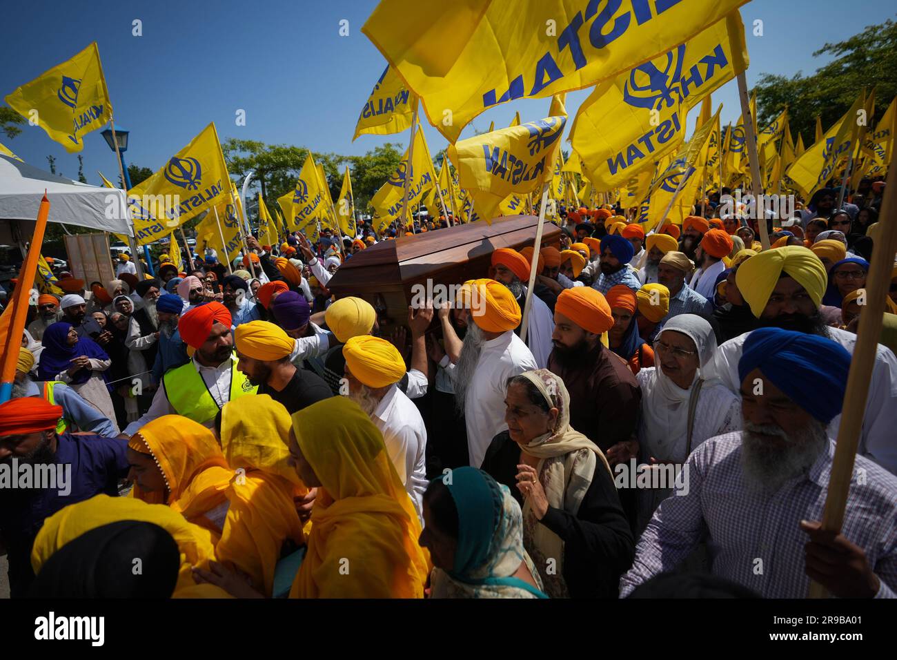 Surrey, Canada. 25th June, 2023. Mourners carry the casket of Sikh community leader and temple ...