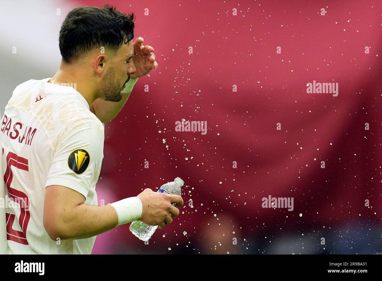 Qatar's Bassam Al-Rawi splashes water on his face during the first half ...
