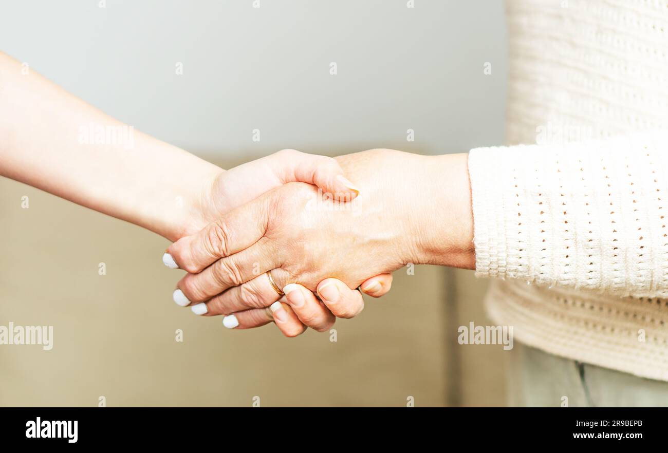Woman nurse shaking hands hi-res stock photography and images - Alamy