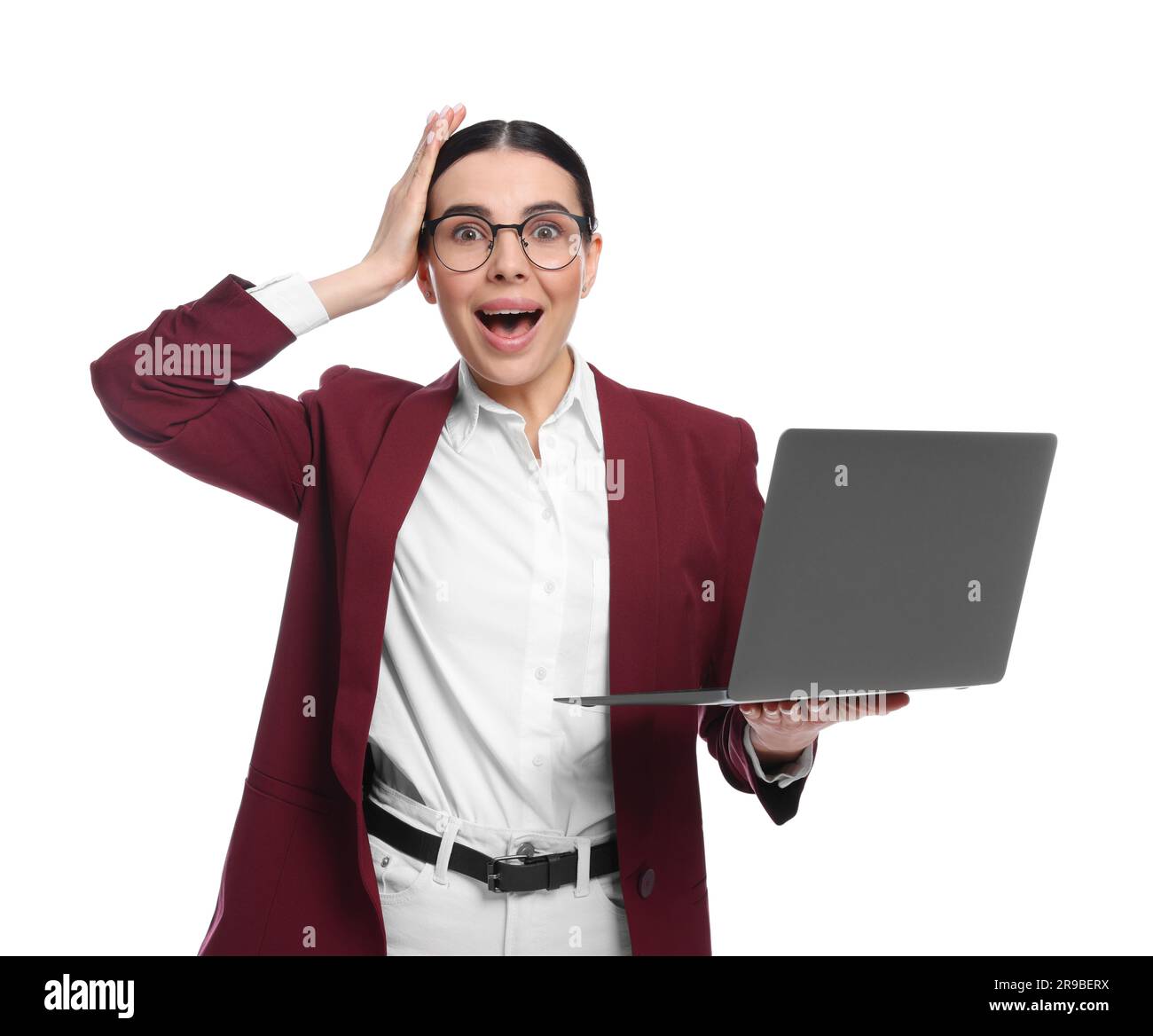 Shocked woman with laptop on white background Stock Photo - Alamy
