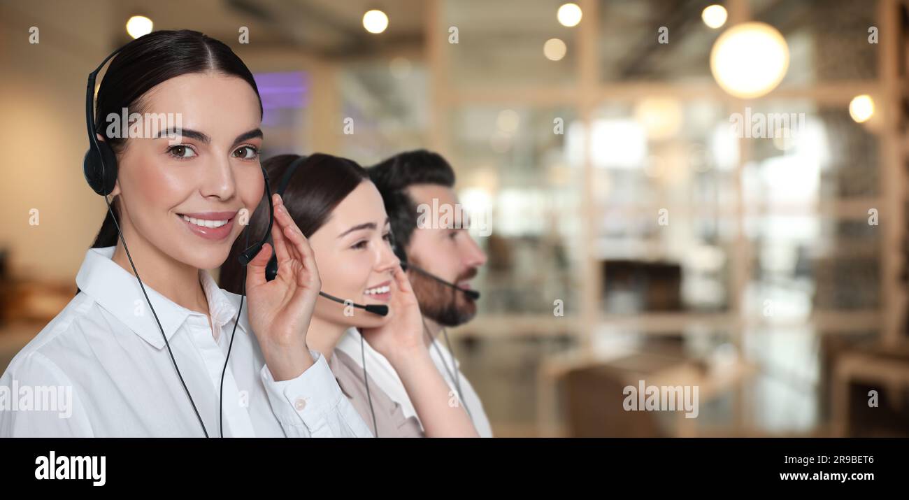 Hotline operators with headsets in office, space for text. Banner ...