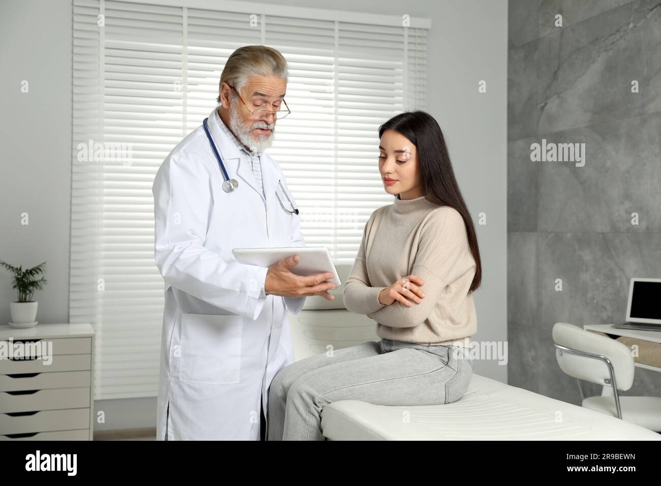 Patient having appointment with senior doctor in clinic Stock Photo - Alamy