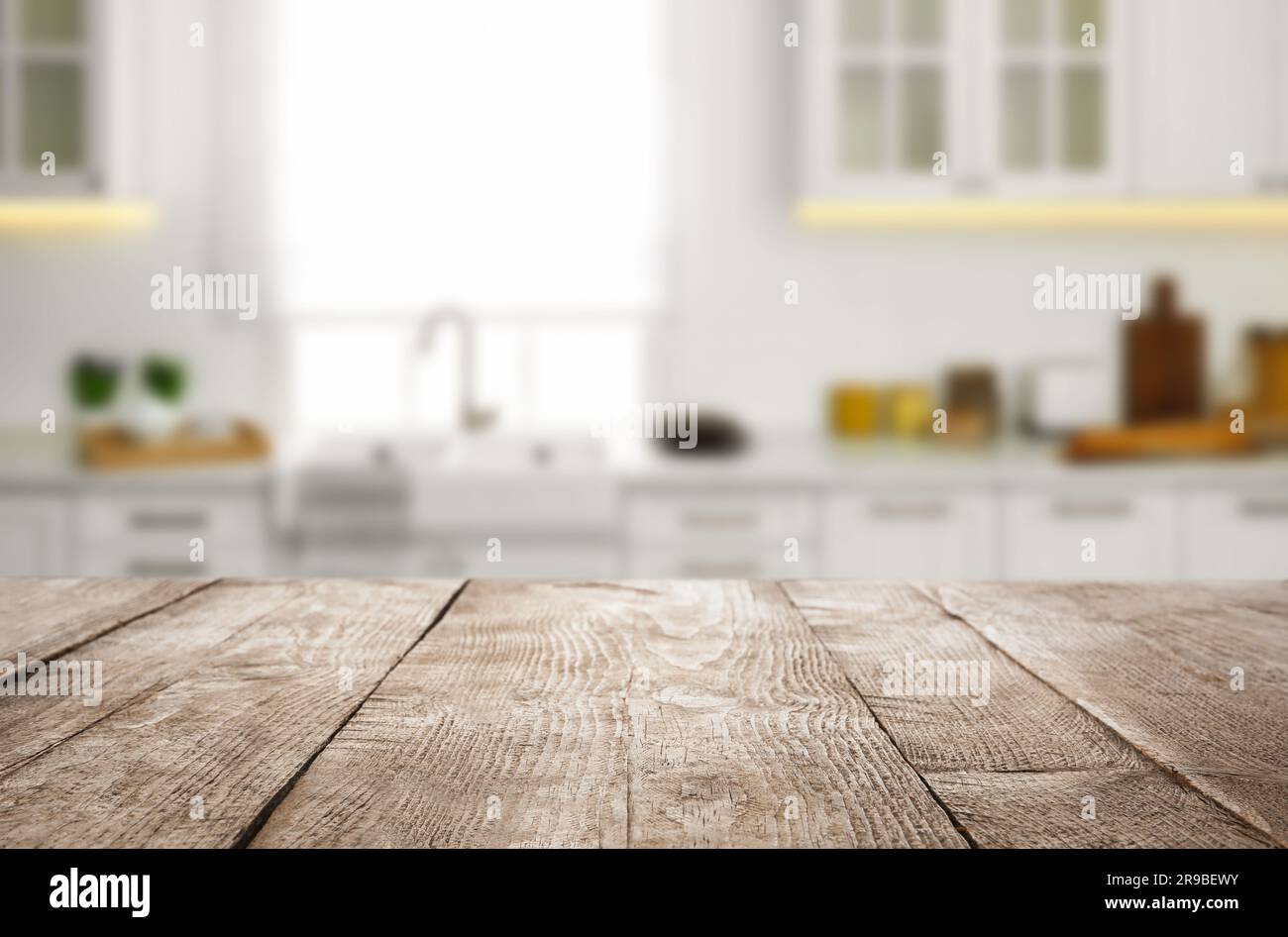 Empty wooden table in beautiful kitchen. Space for design Stock Photo ...