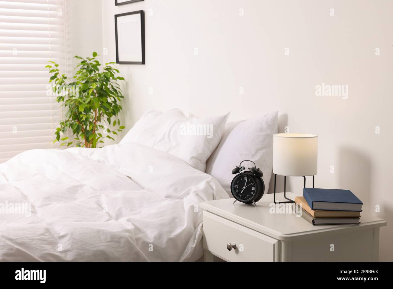 Stylish light room with comfortable bed and bedside table. Interior ...