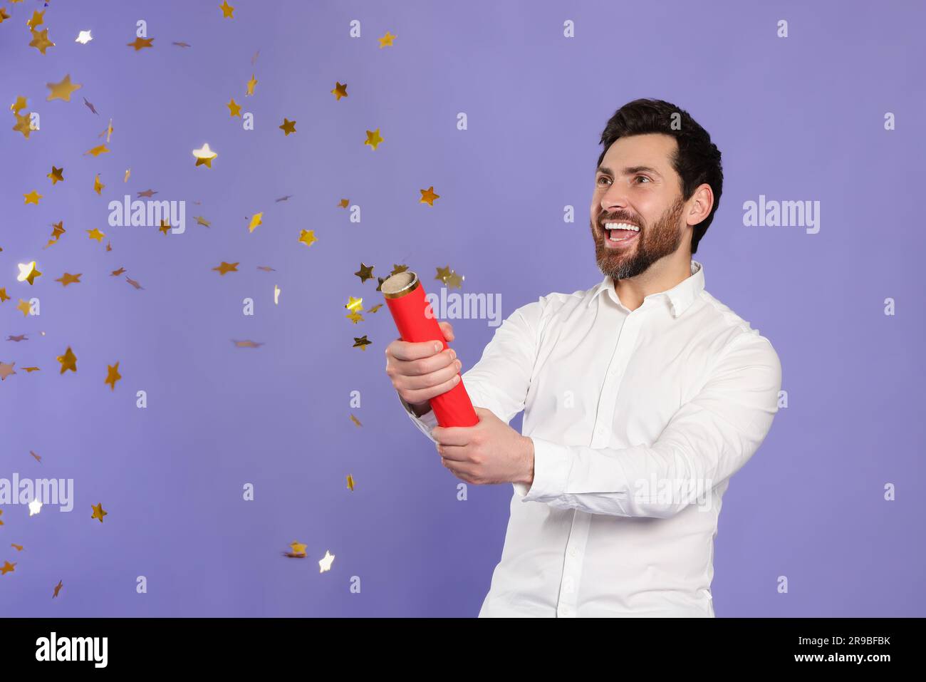 Handsome man party popper hi-res stock photography and images - Alamy