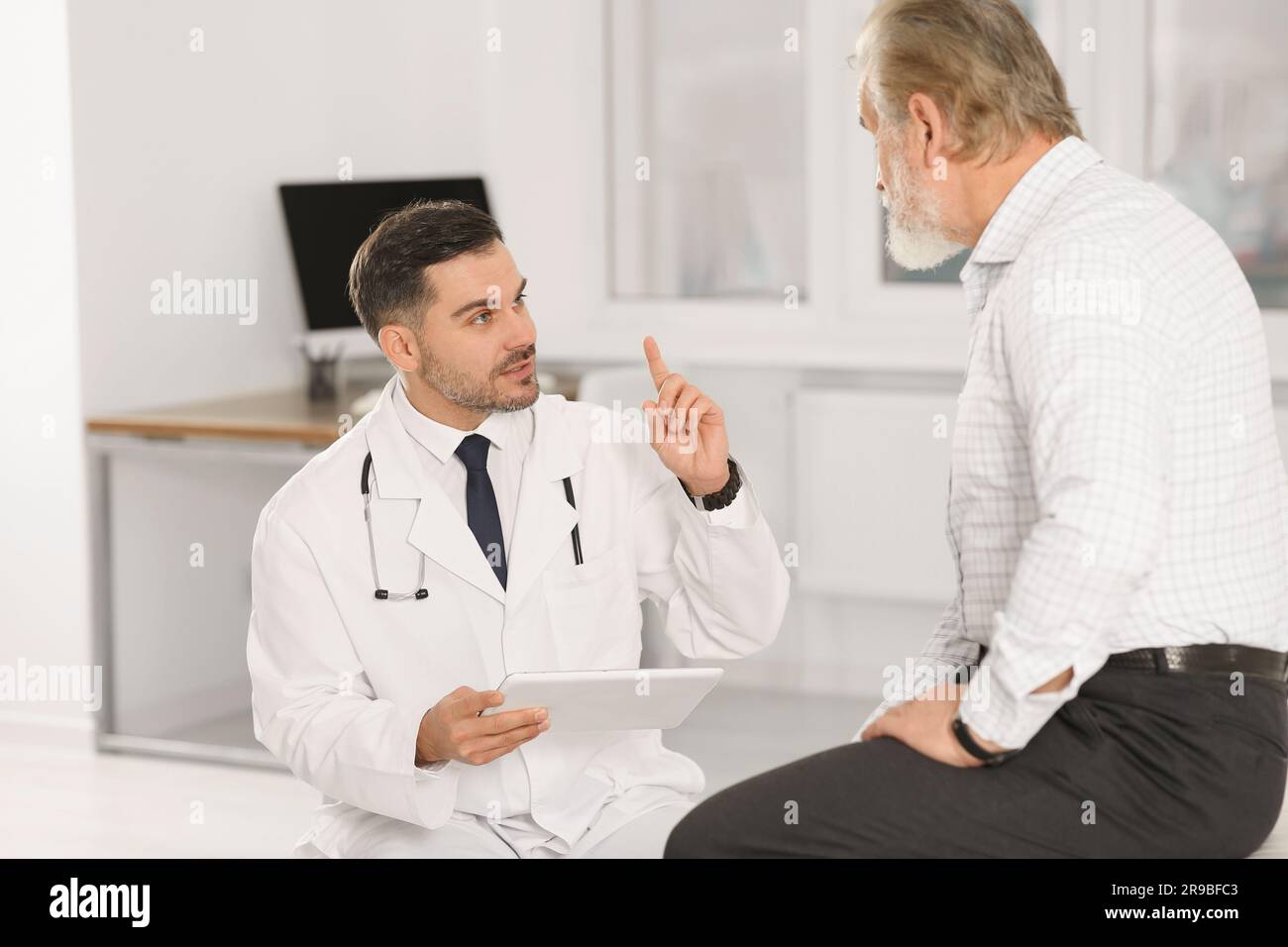 Senior patient having appointment with doctor in clinic Stock Photo - Alamy