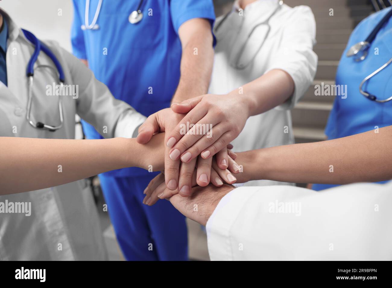 Team of medical doctors putting hands together indoors, closeup Stock ...