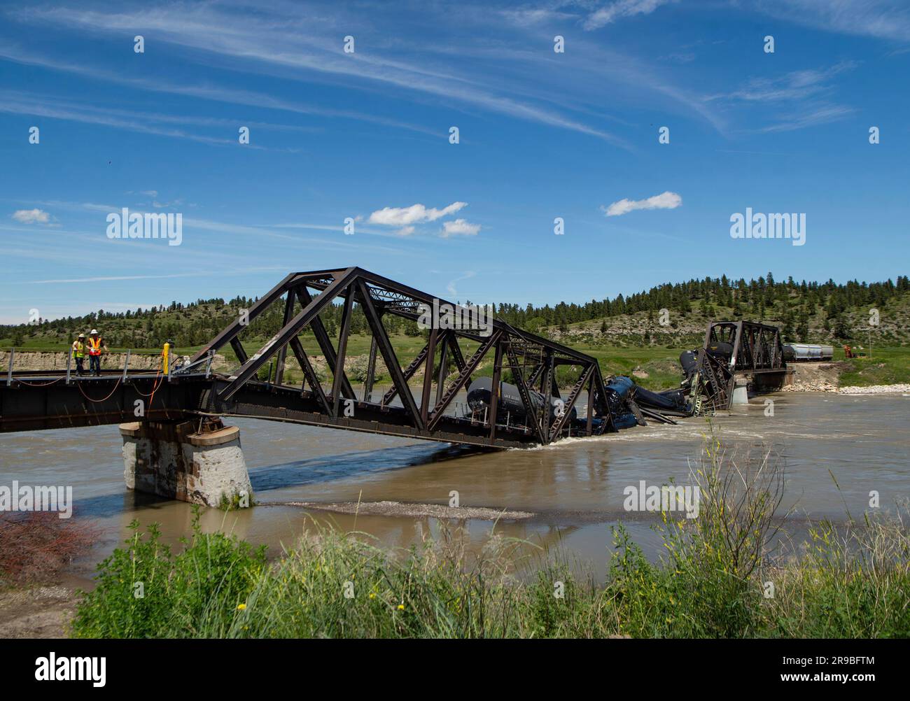 Rail cars remain in the river Sunday, June 25, 2023, after a railroad ...