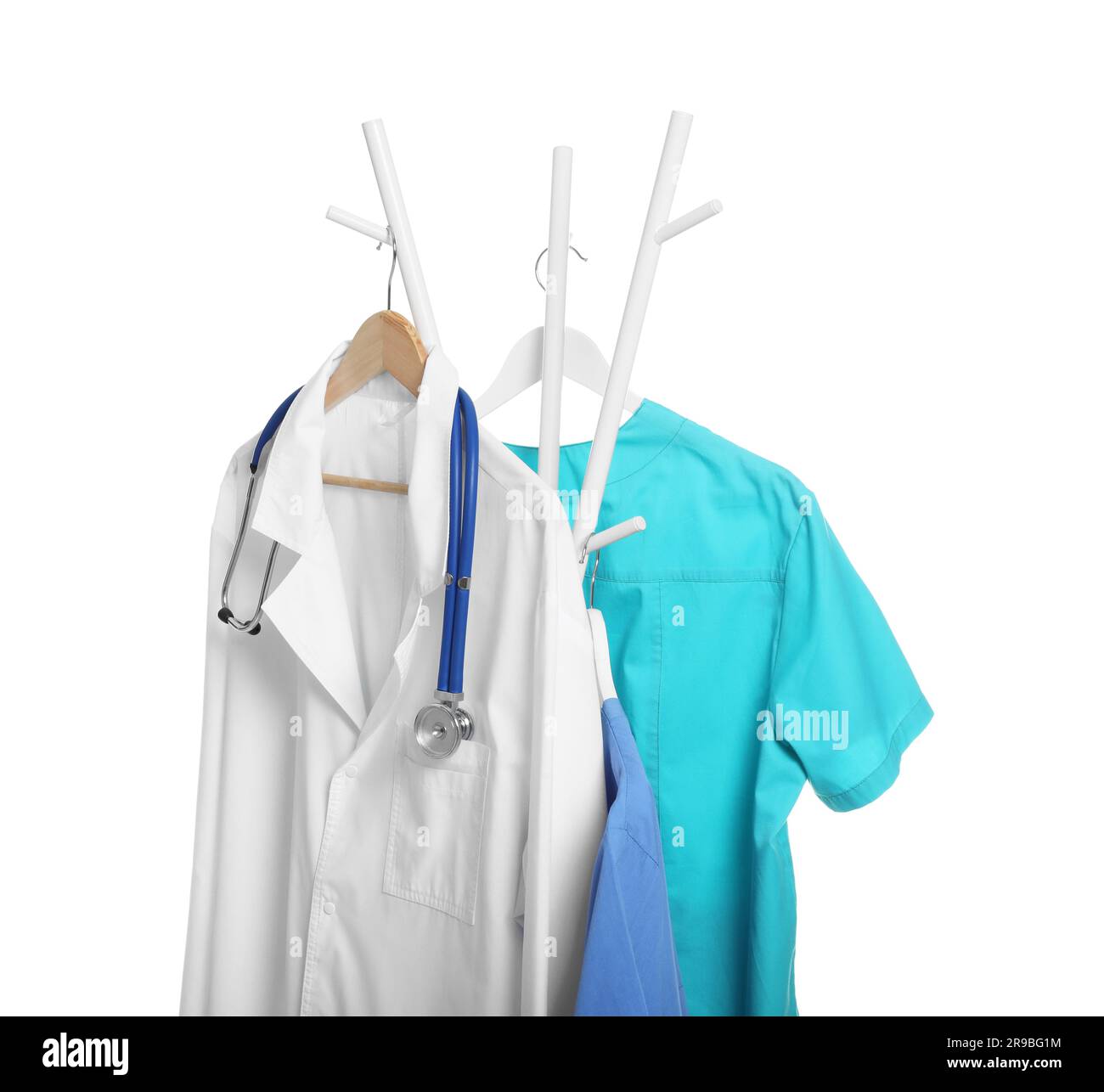 Doctor's gown with stethoscope and medical uniform on rack against ...