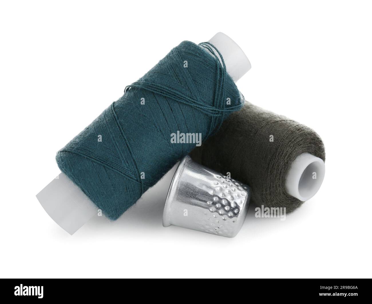Thimble and spools of sewing threads isolated on white Stock Photo - Alamy