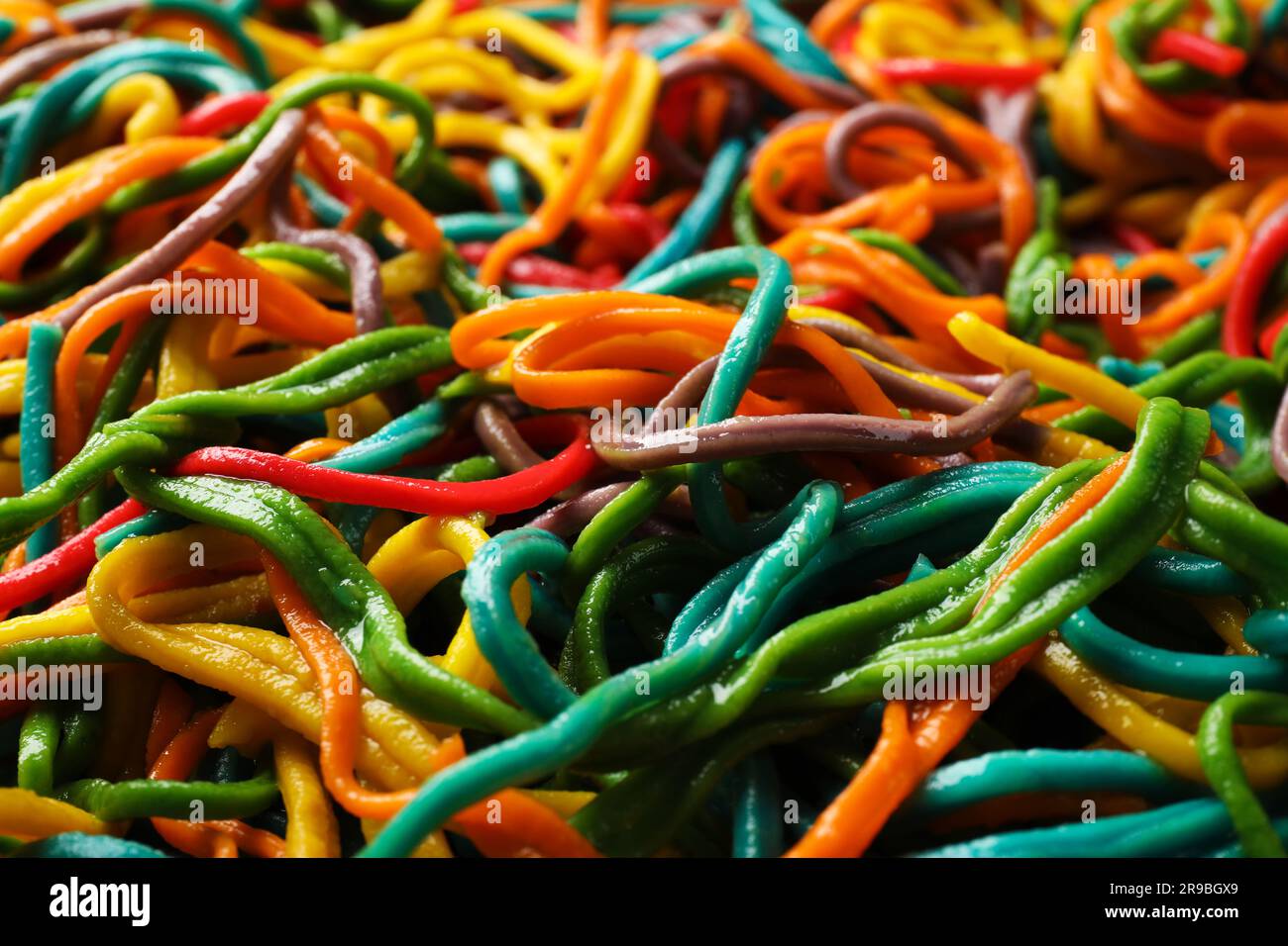 Spaghetti painted with different food colorings as background, closeup ...