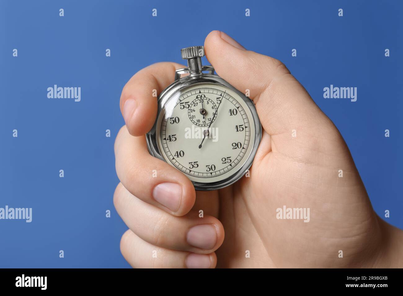 Man holding vintage timer on blue background, closeup Stock Photo - Alamy
