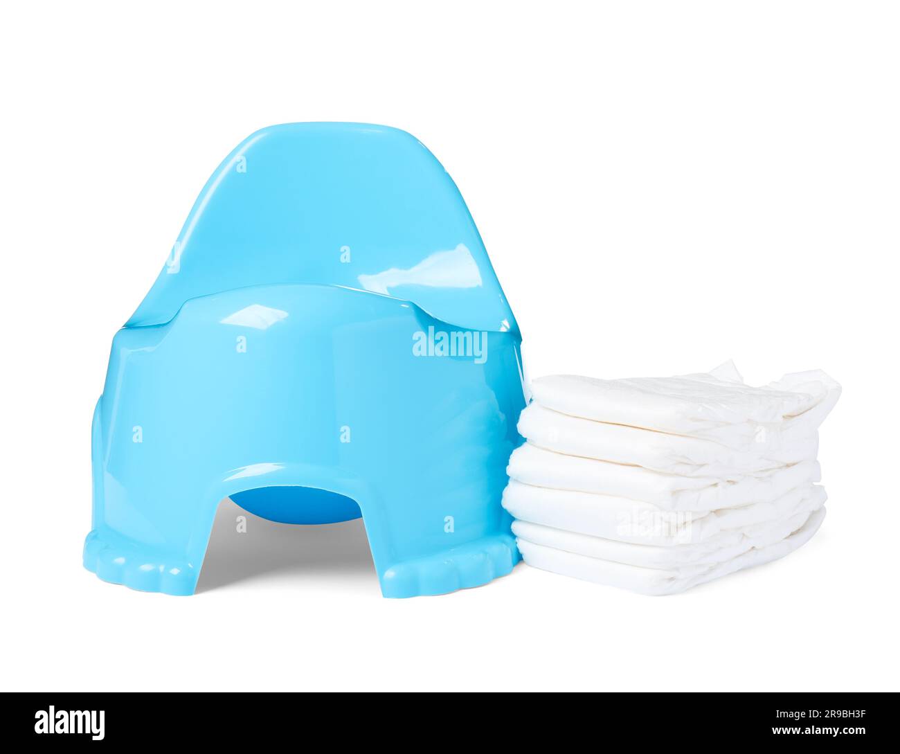 Light blue baby potty and stack of diapers isolated on white. Toilet ...