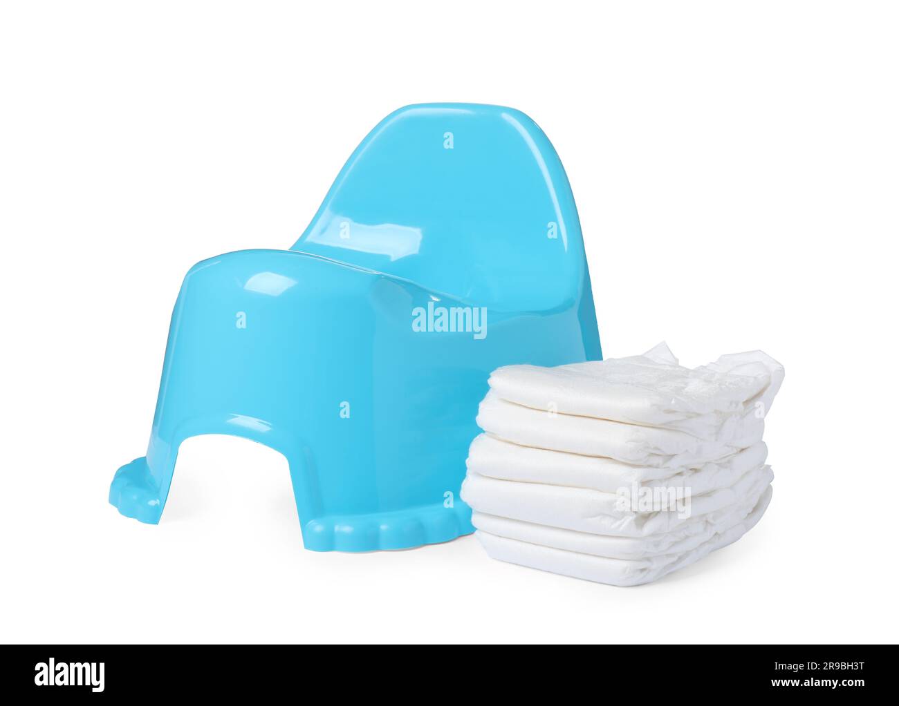 Light blue baby potty and stack of diapers isolated on white. Toilet ...